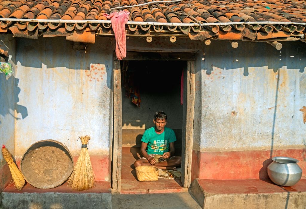 : Purulia: A beedi worker cuts a dry leaf to make 'Beedi