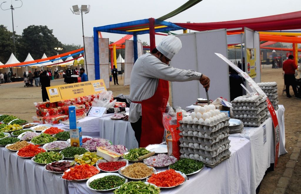 A chef prepares food for visitors at the 12th National Street Food Festival