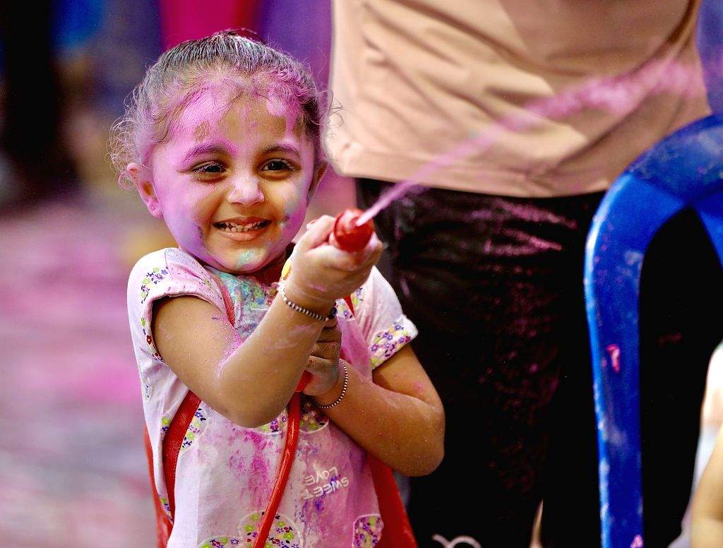 A child plays Holi during celebrations