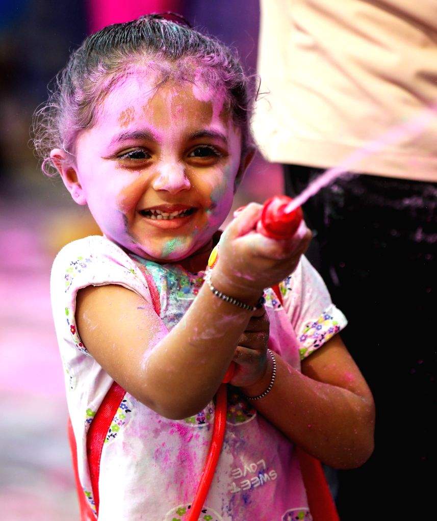A child plays Holi during celebrations