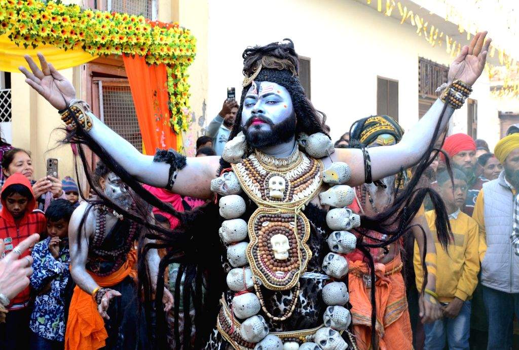 A devotee dressed as Lord Shiva participates in a religious procession ...