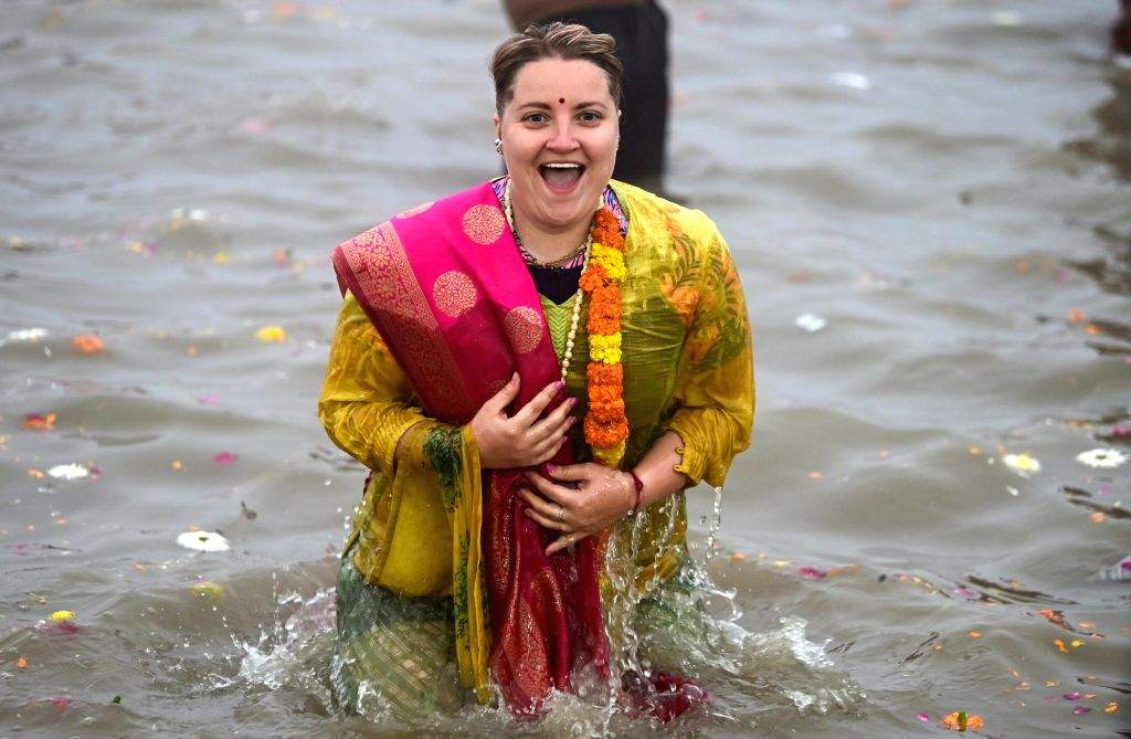 A devotee takes a holy dip at the Triveni Sangam