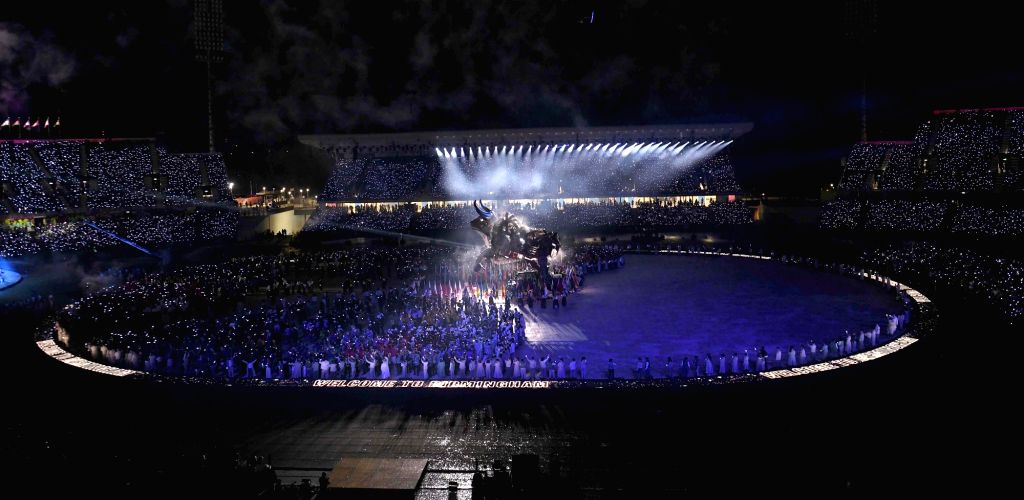 A giant mechanical bull is seen illuminated during the Commonwealth ...