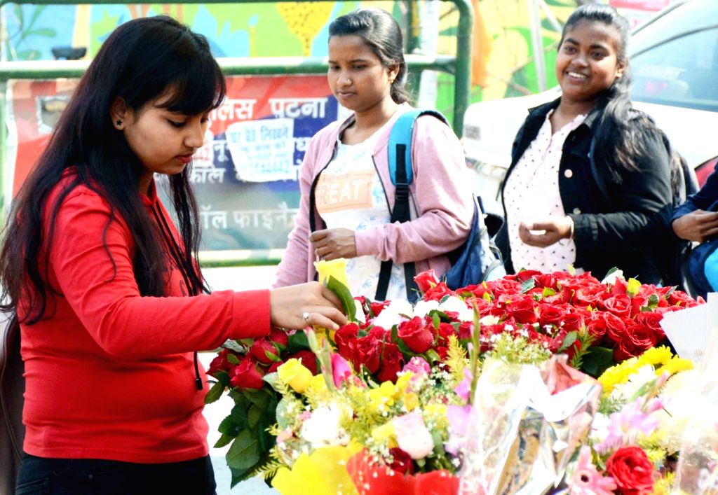 A girl purchases a rose from a shop on a Rose Day