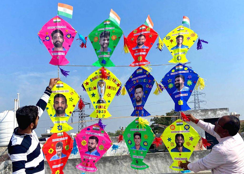 A kitemaker displays kites decorated with pictures of Indian cricketers ...