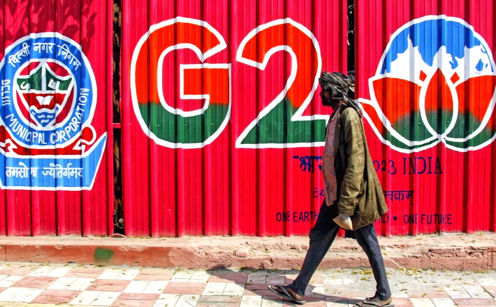 A man walks past a graffiti wall for G20 beautification