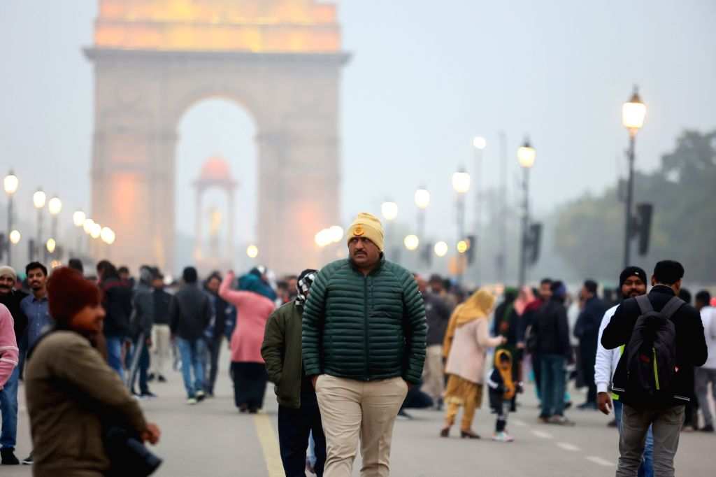 A police officer wearing a jacket patrols at India Gate on a cold ...