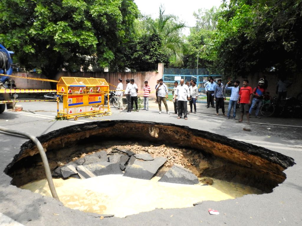 A portion of a road caved in at Posangi Pur Road in New Delhi
