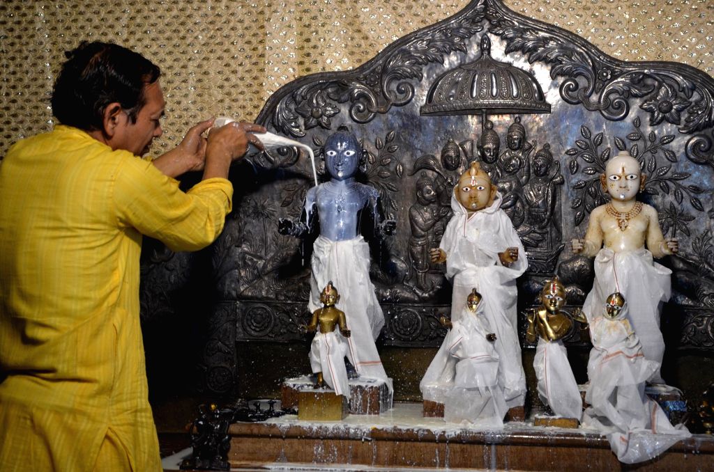 A priest performs 'Abhishek' with milk on Lord Ram