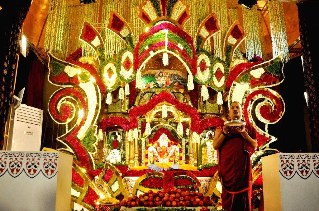 A priest performs rituals while offering prayers to Lord Ganesha