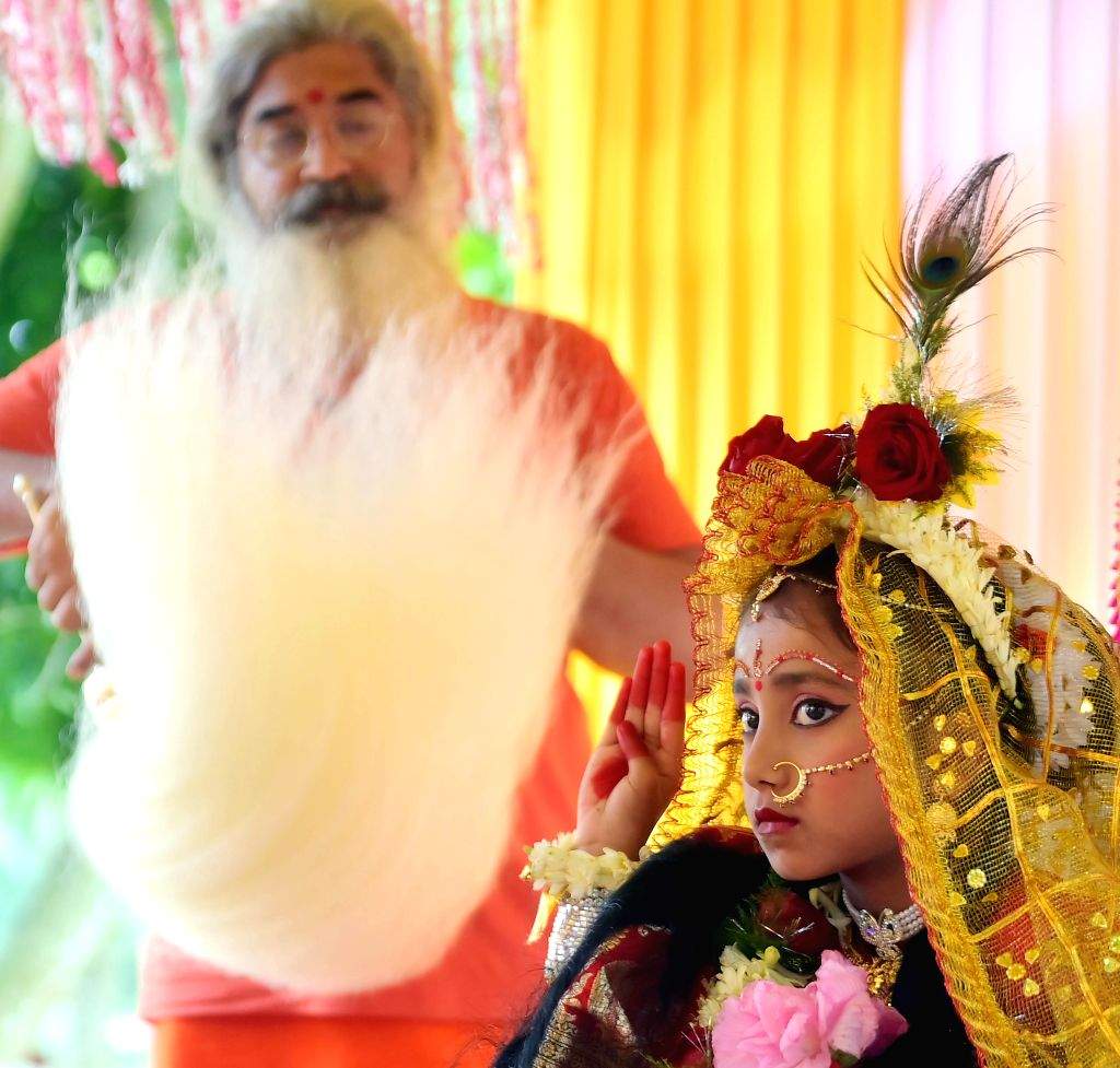 A priest worships a girl, known as a "Kumari," during the Kumari Puja