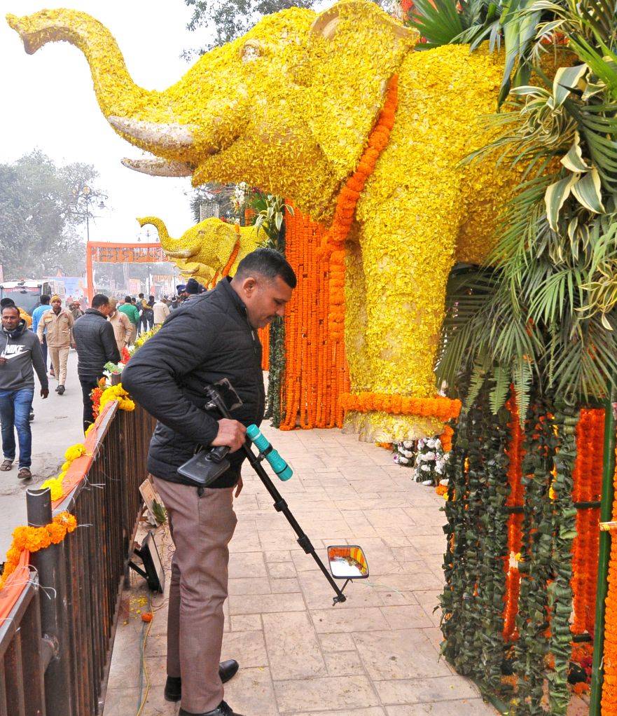 A security personnel stands guard ahead of the Ram temple consecration ...