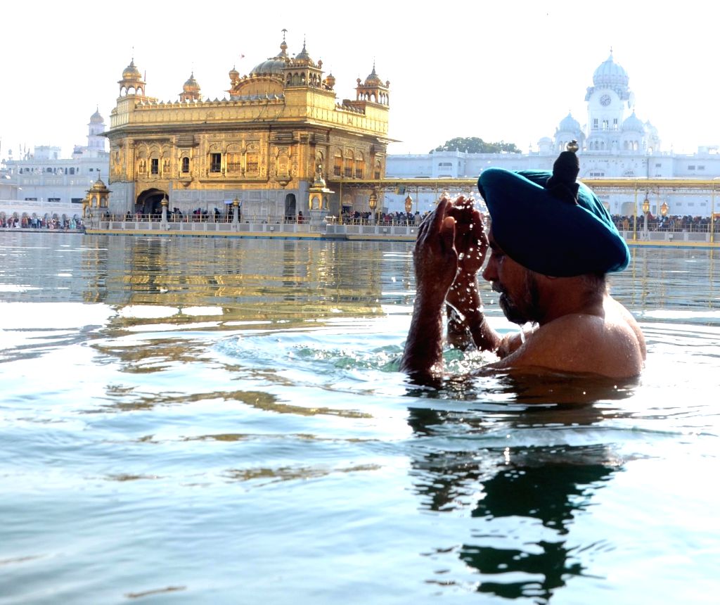 A Sikh devotee takes a dip in the holy sarovar.