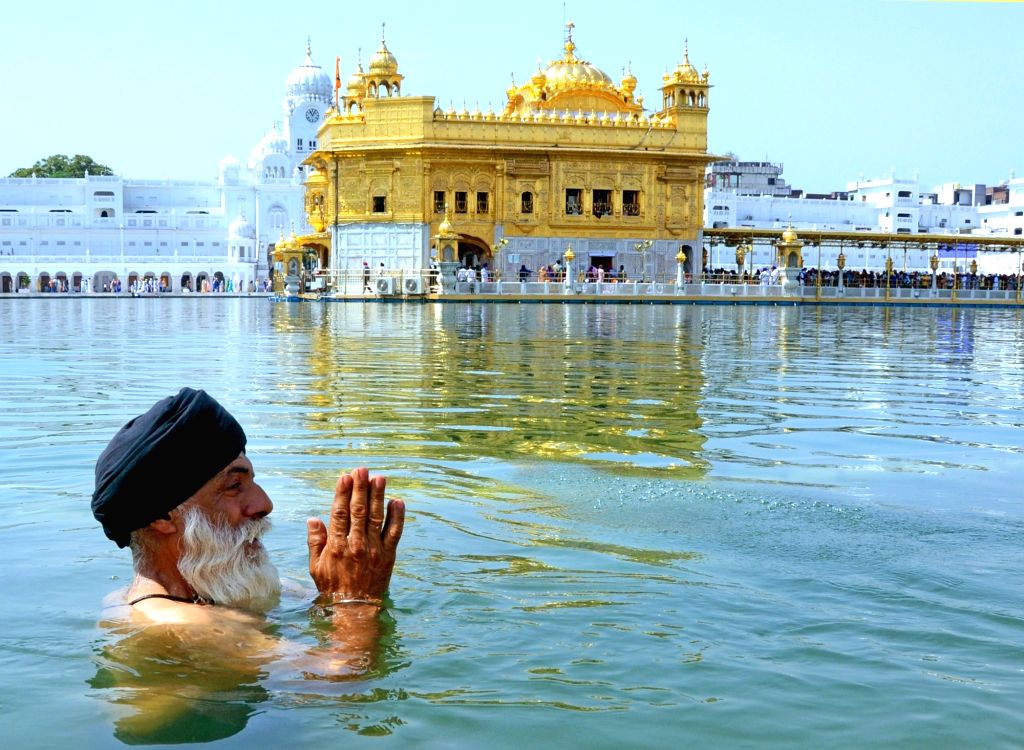 A Sikh devotee takes a dip in the holy 'Sarovar