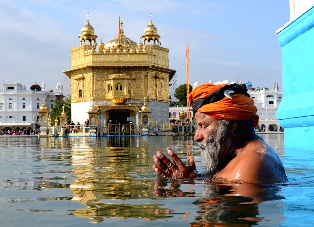 A Sikh devotee takes a holy dip in the 'Sarovar
