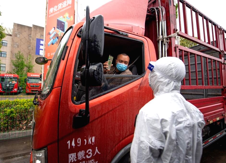 A staff member checks the health code of a driver entering the Hangzhou ...