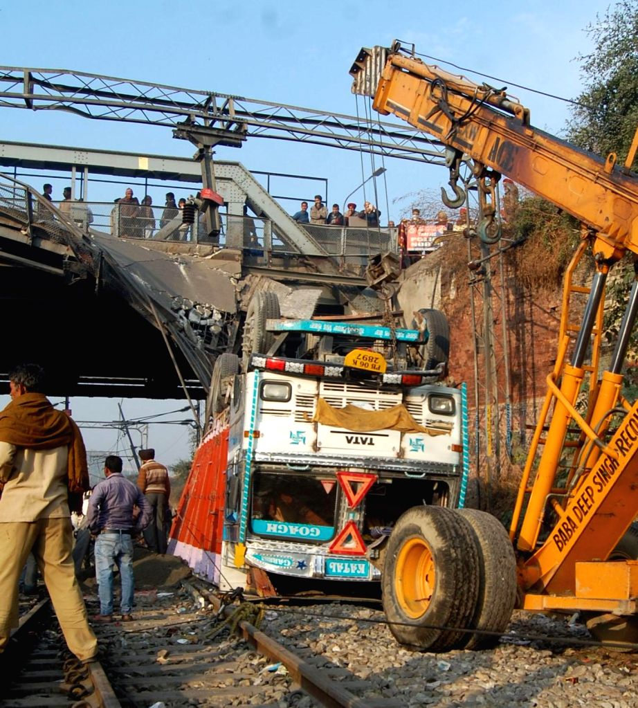 Truck falls on railway tracks as after a bridge collapsed