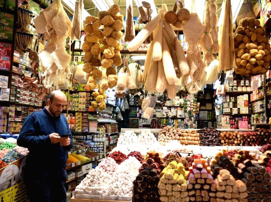 A Turkish vendor looks at his mobile phone in his shop at the Spice ...