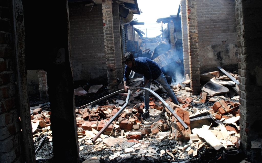 A view of Burn shops and Eight people rescued from the fire in a ...