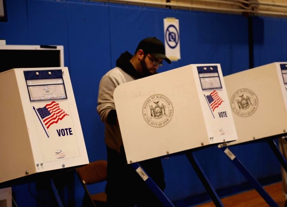 New York :A voter fills in his ballot at a polling station in New York