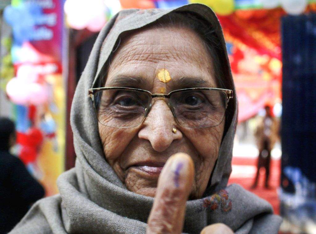 A voter shows her ink-marked finger after casting her vote for the ...