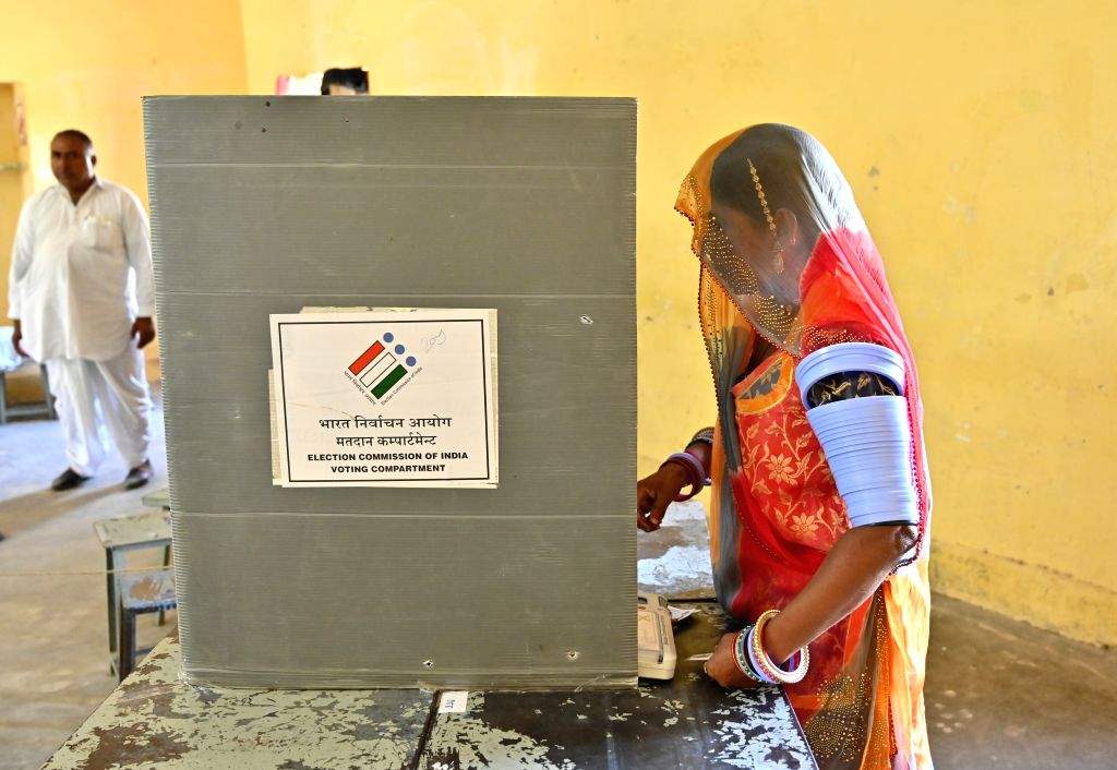 A woman casting her vote during the second round of Lok Sabha voting