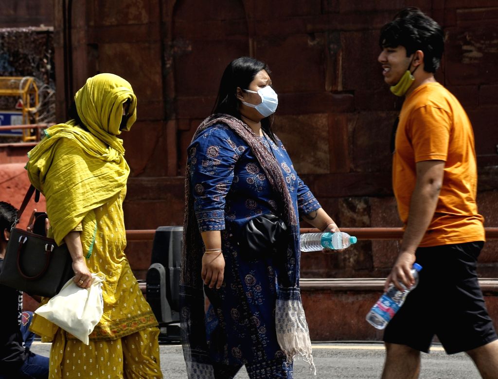 A woman covering herself with a cloth to protect from sunlight