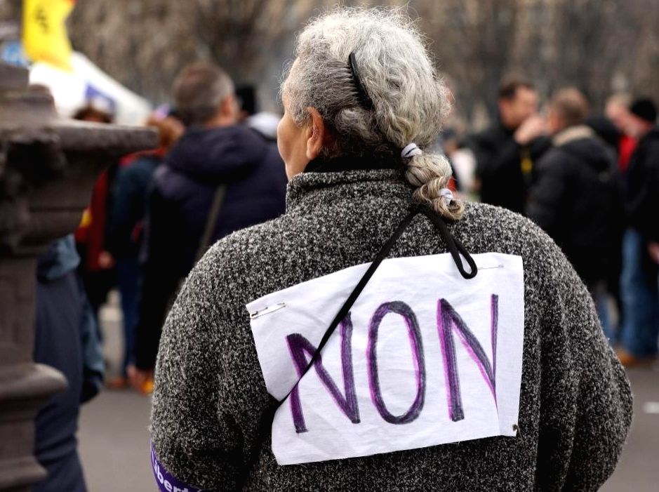 A woman demonstrates against the government's pension reform plan in Paris