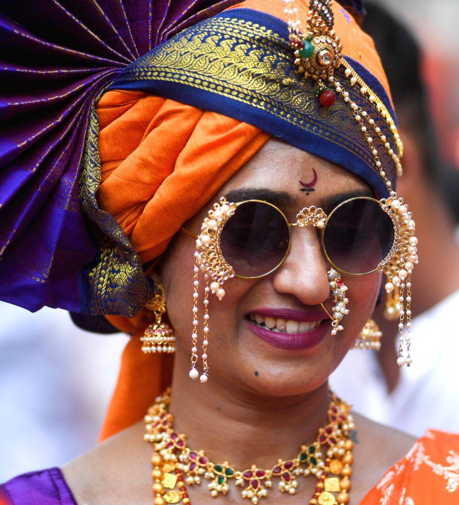 A woman dressed in traditional attire participates in a rally on the ...