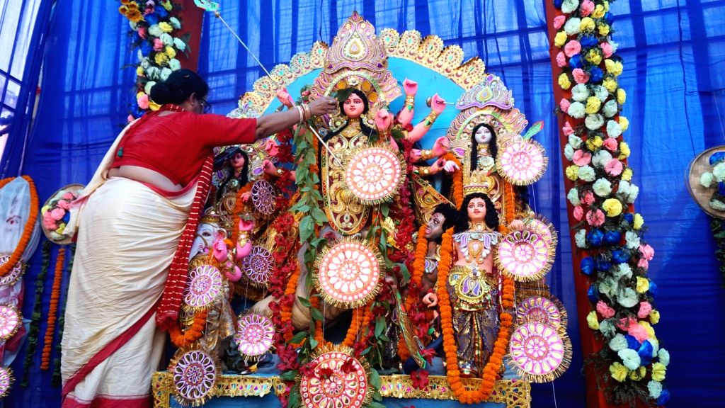 A woman priest performing rituals to Goddess Durga idol to celebrate ...