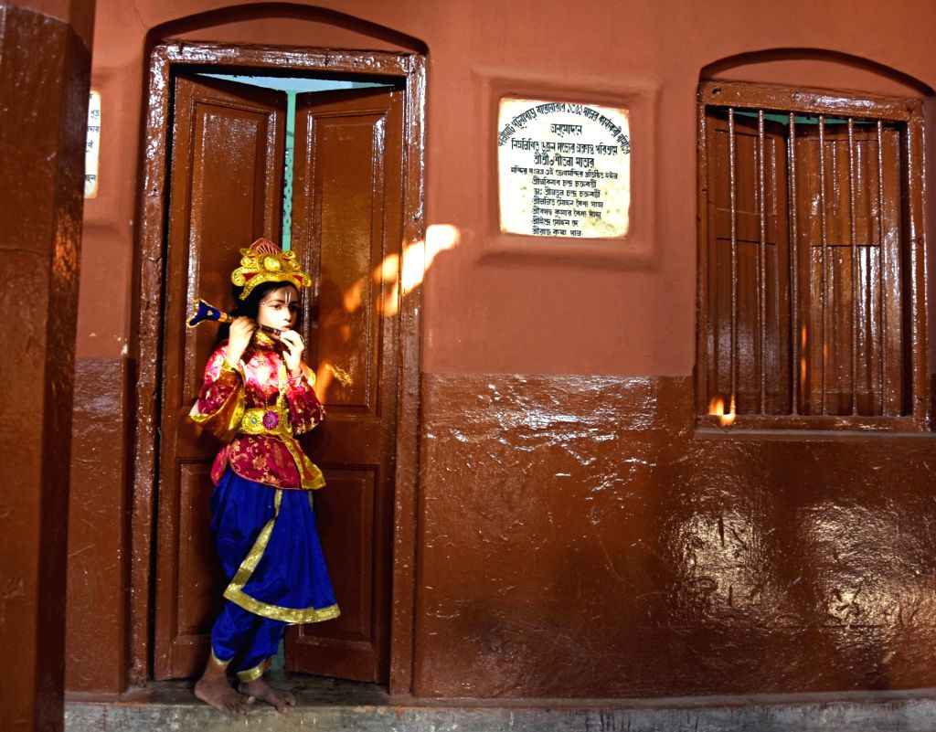 A young boy dressed as Lord Krishna during the celebration of 'Chadak ...