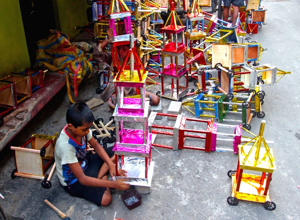 Kolkata : A young boy prepares wooden Raths ahead of the 'Rath Yatra