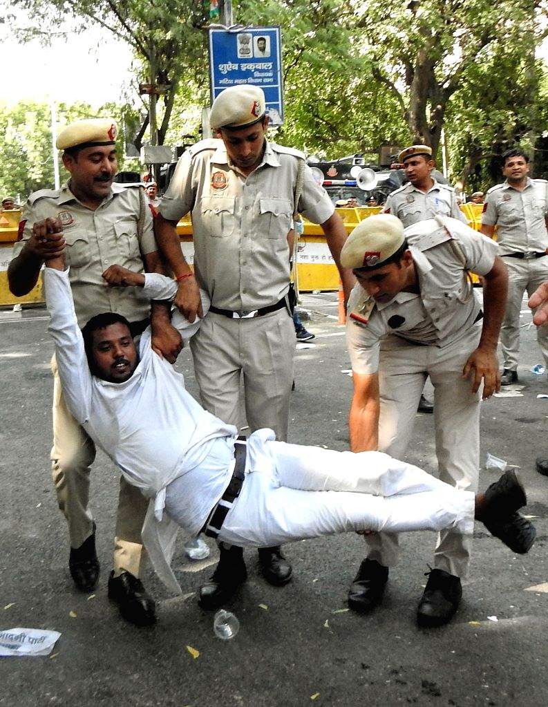 AAP members stage a protest against the arrest of MP Sanjay Singh near ...