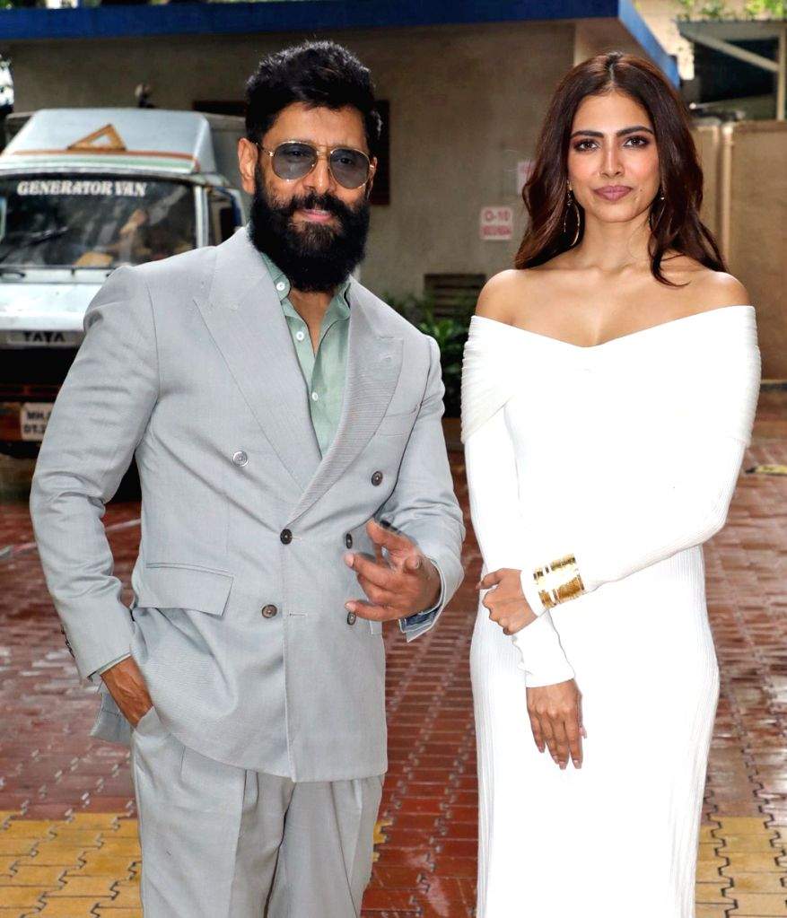 Actors Vikram and Malavika Mohanan pose for photos during the promotion ...