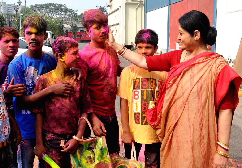 Underprivileged children play Holi