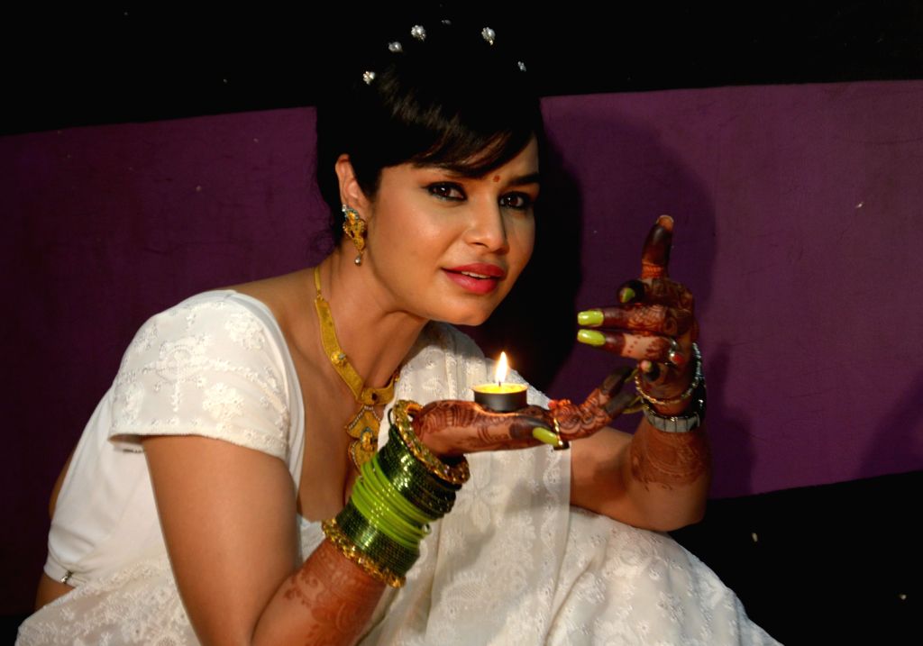 Actress Kavitta Verma poses with a Diya