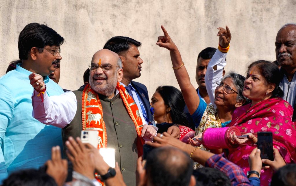 : Ahmedabad :Amit Shah along with his wife flies a kite during Makar ...