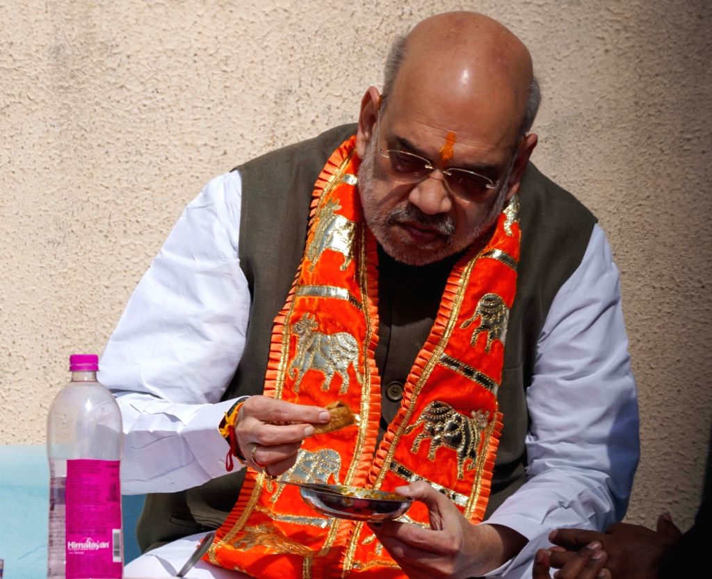 : Ahmedabad :Union Home Minister Amit Shah having 'Undhiyu' during ...
