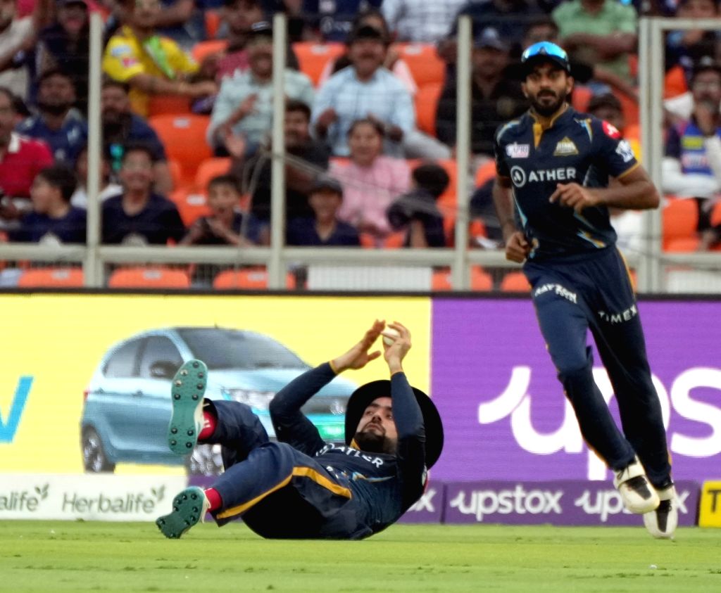 Ahmedabad : GT's Rashid Khan dives to take a successful catch to ...
