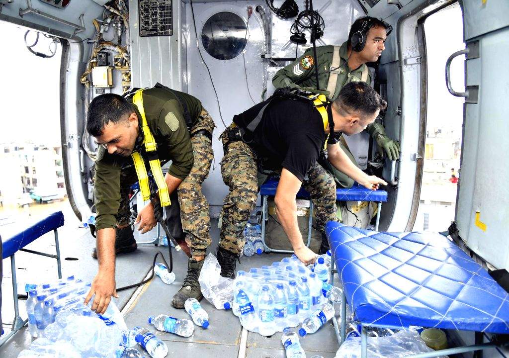 Air Force personnel deliver food and water to flood-affected residents ...