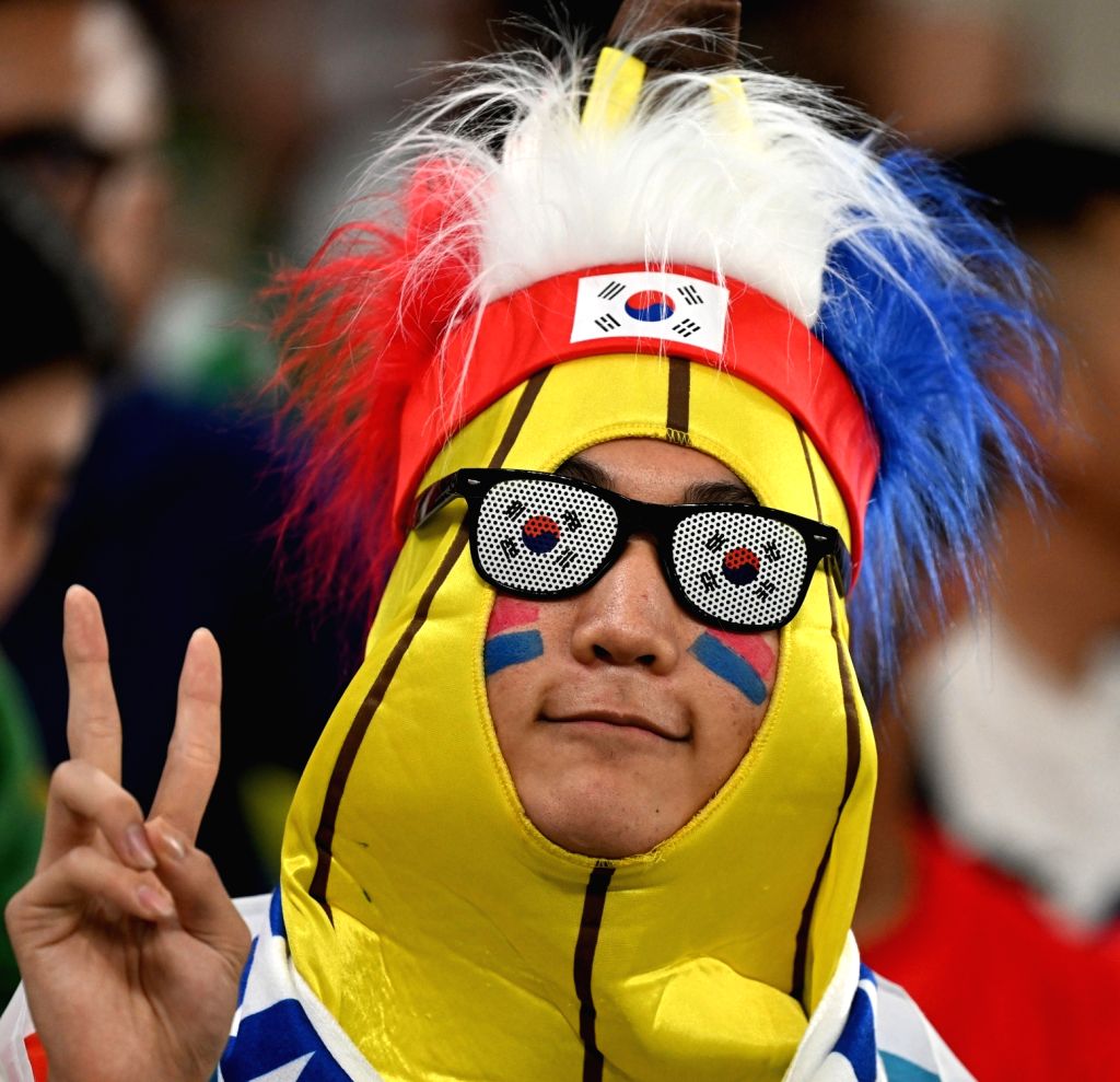 : Al Rayyan:A soccer fan awaits the start of the World Cup group H ...