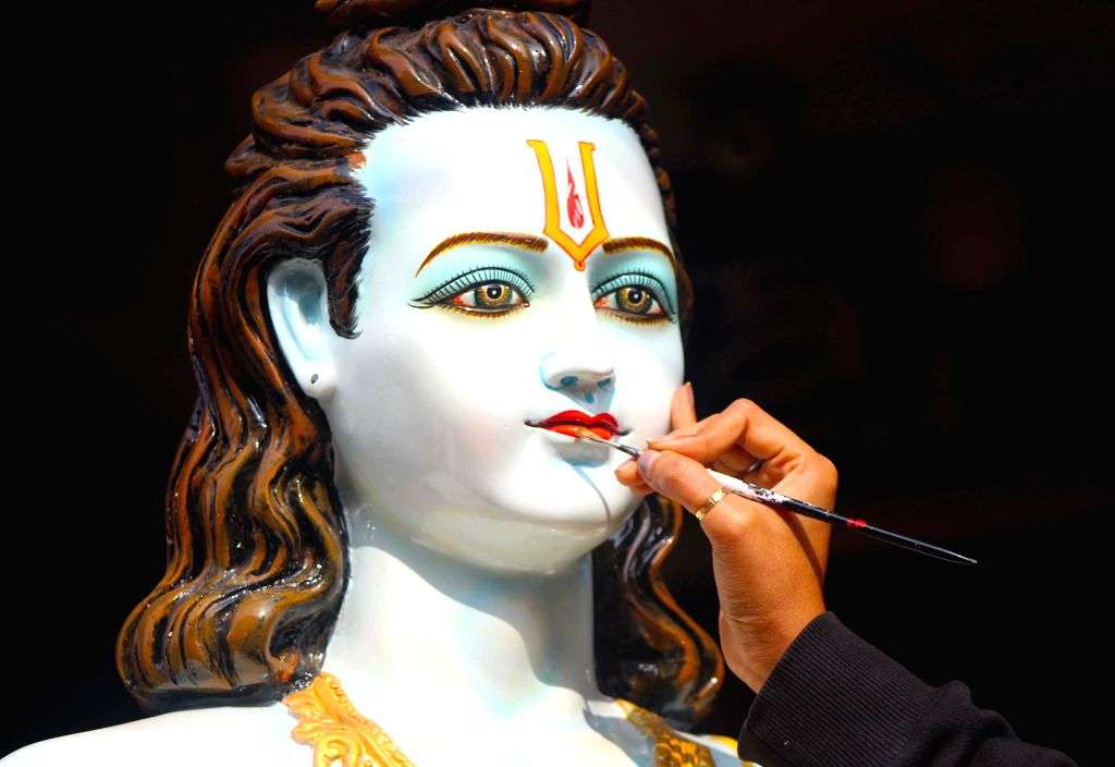 An artist gives final touches to the idol of Lord Ram ahead of Shri Ram ...