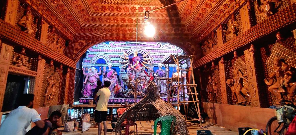 : Balurghat: An artist prepares a clay idol of Goddess Durga at a ...
