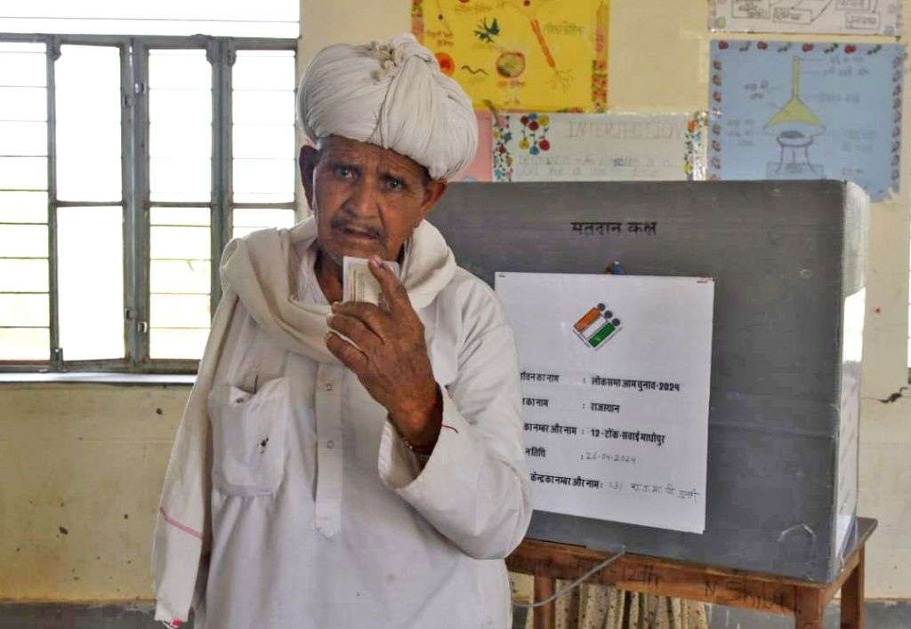 An elderly voter showing mark of indelible ink after casting his vote ...