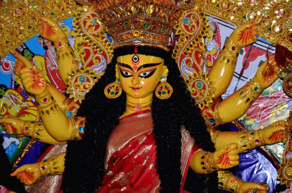 An idol of goddess Durga at a community puja pandal during the Durga ...