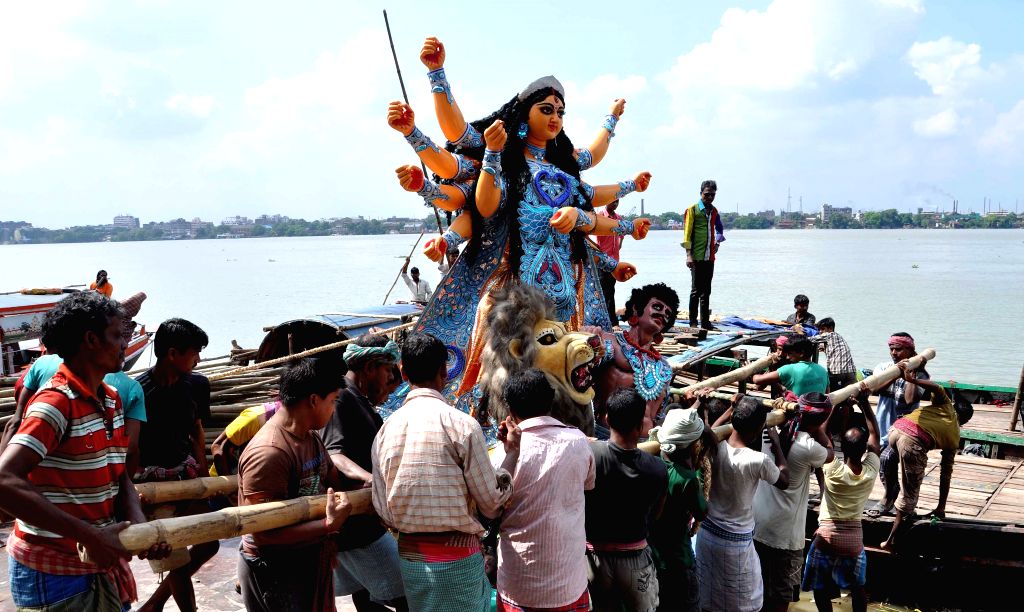 Durga idol being transported by boat