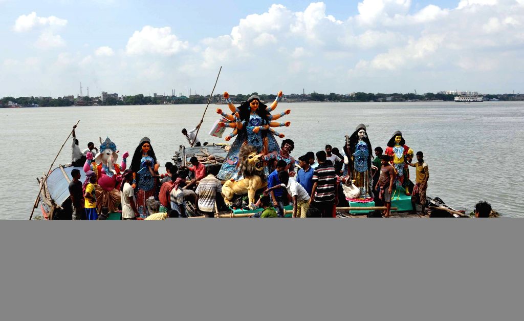 Durga idol being transported by boat