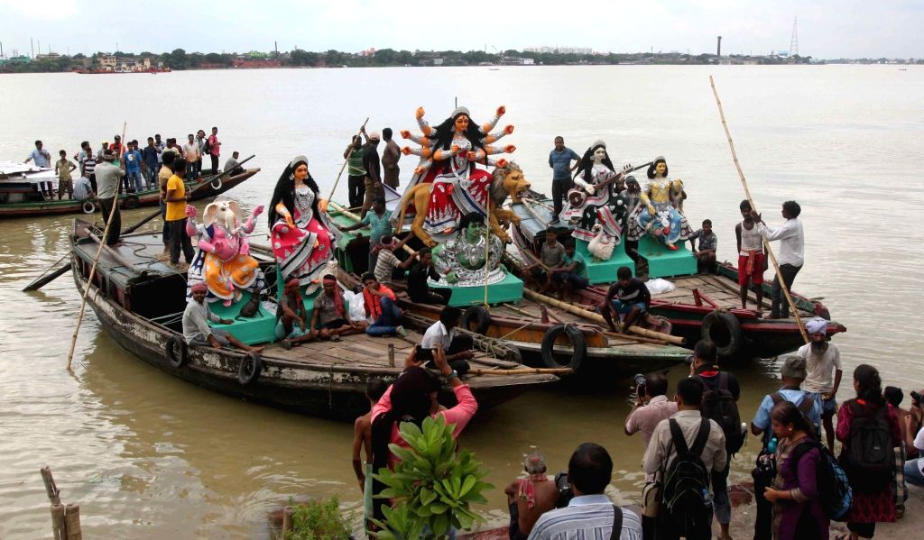 Durga idol being transported on boat