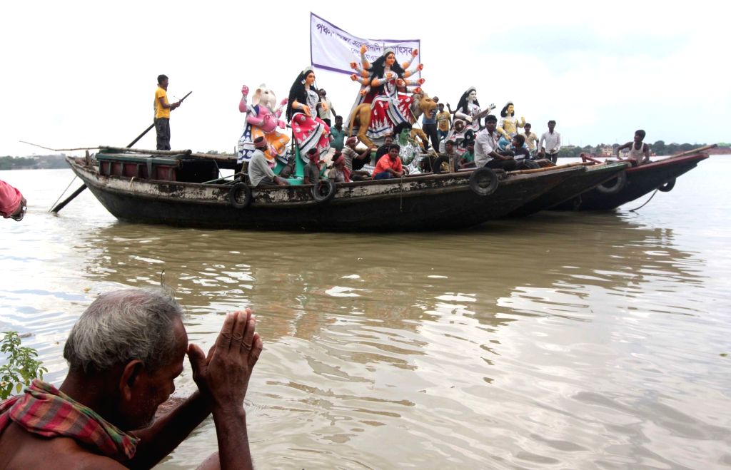 Durga idol being transported on boat
