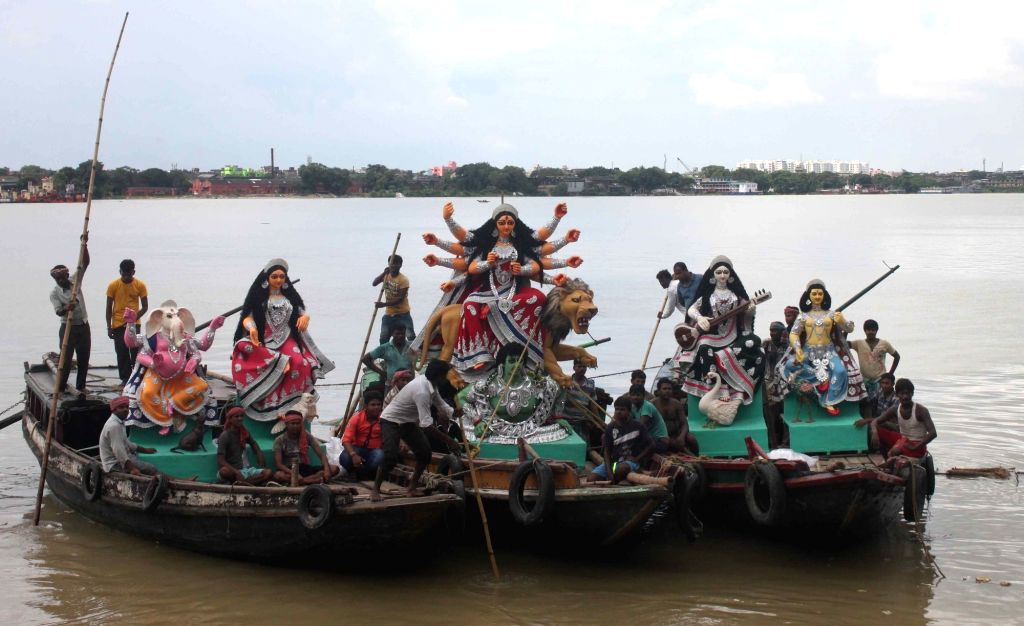 Durga idol being transported on boat